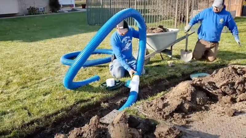 How to Run Downspouts Under a Sidewalk